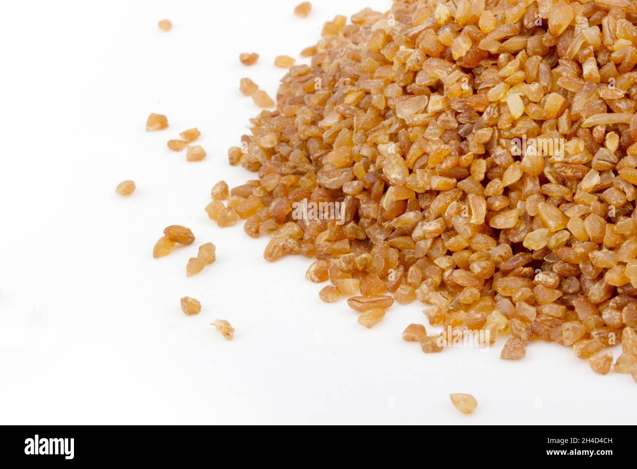 brown bulgur on a white background Stock Photo - Alamy