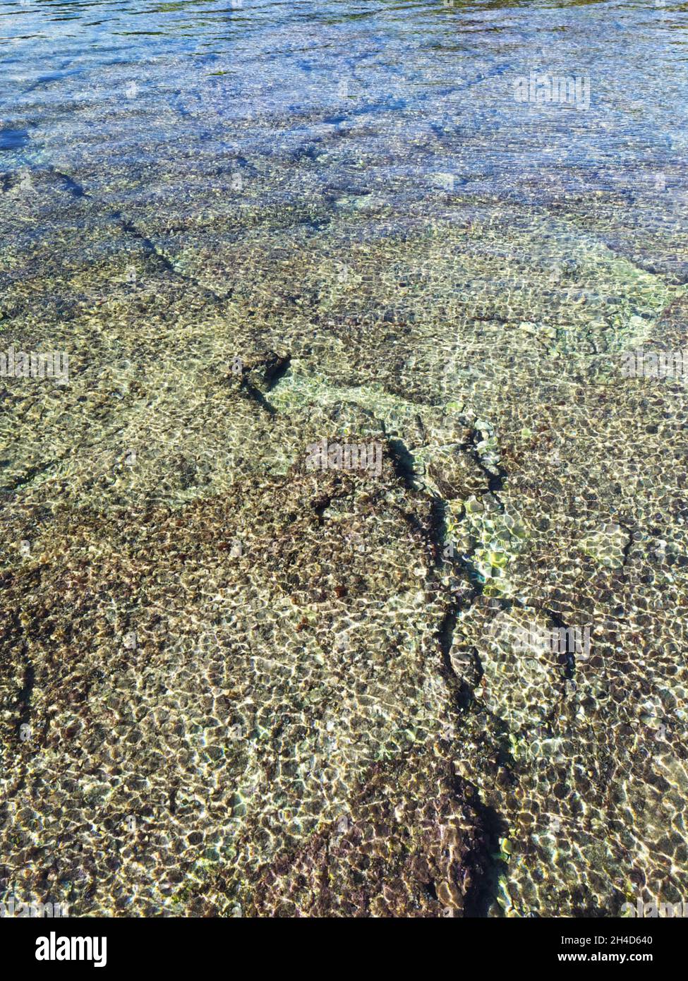 Clear see and underwater cracked rocky surface Stock Photo - Alamy
