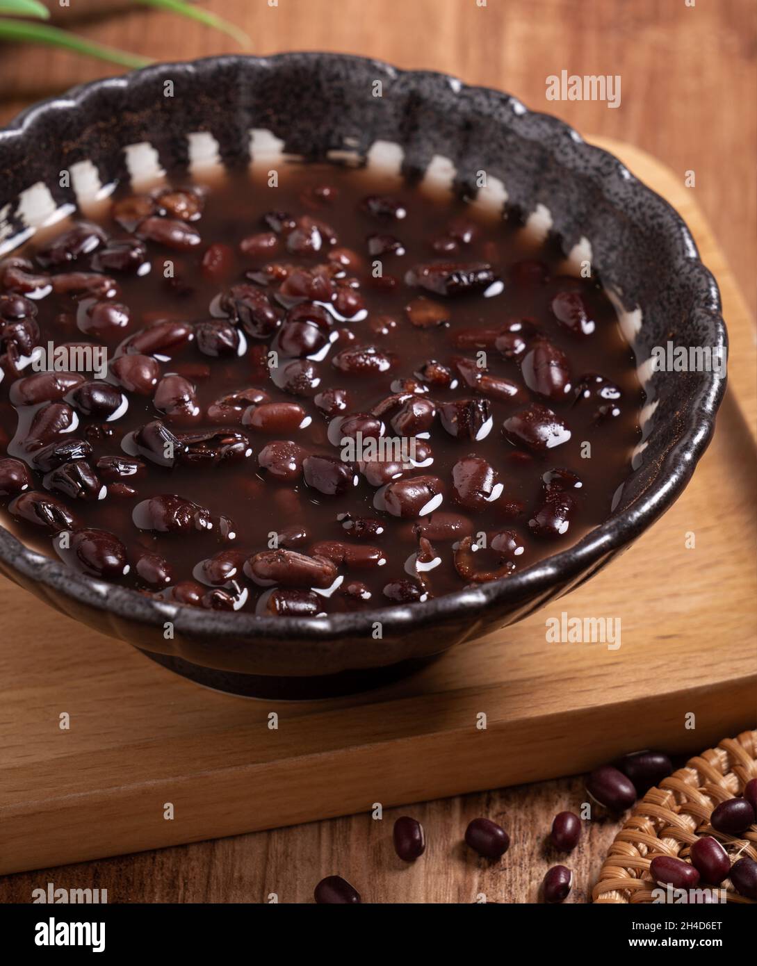 Close up of adzuki red bean soup in a bowl on wooden table background ...