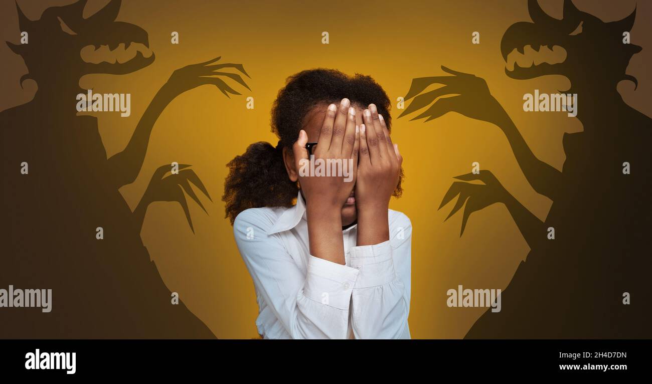 Phobias And Inner Fears Concept. Little Black Girl Afraiding Of Shadow ...
