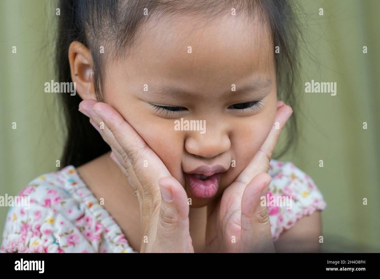 Child girl portrait touch face closeup hi-res stock photography and ...