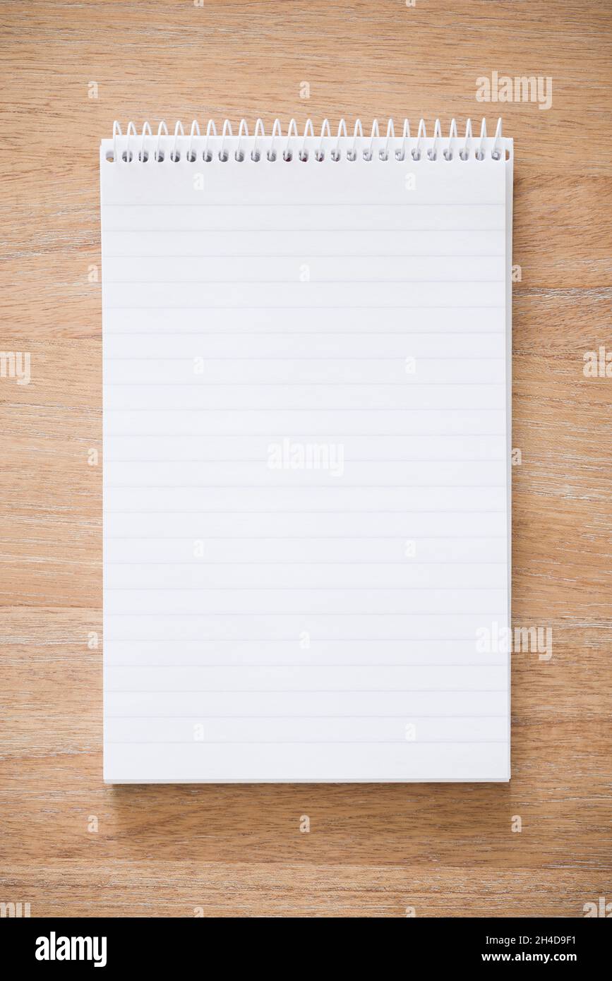 White Secretary notepad open on a wood desk. Background or template ...