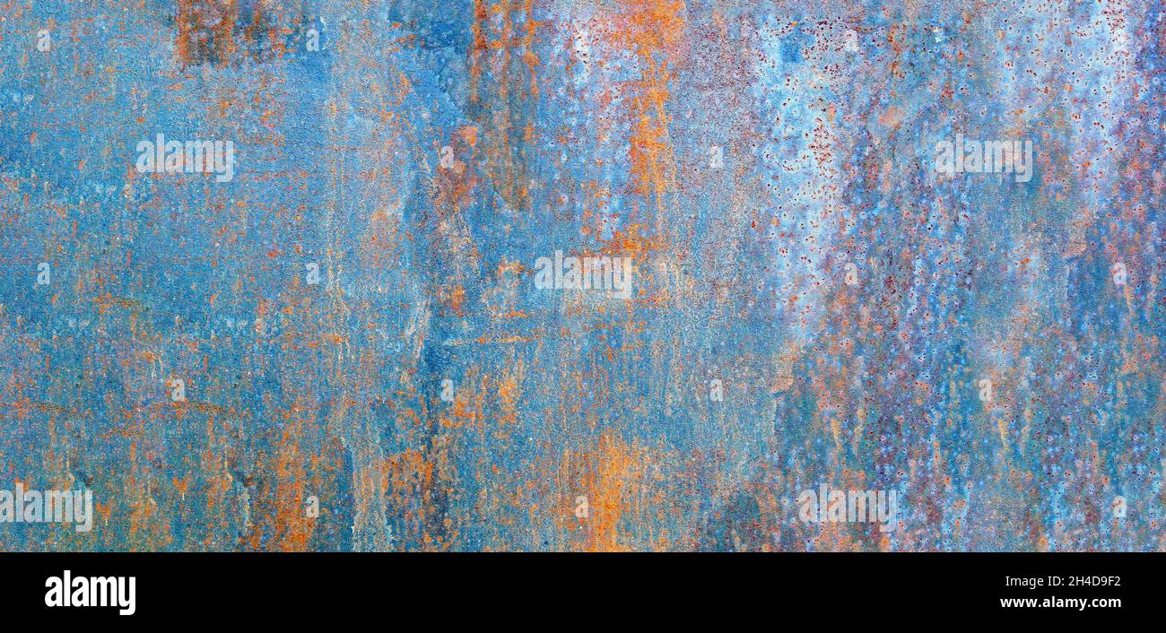 Background: rusty metal surface with blue paint flaking and cracking ...
