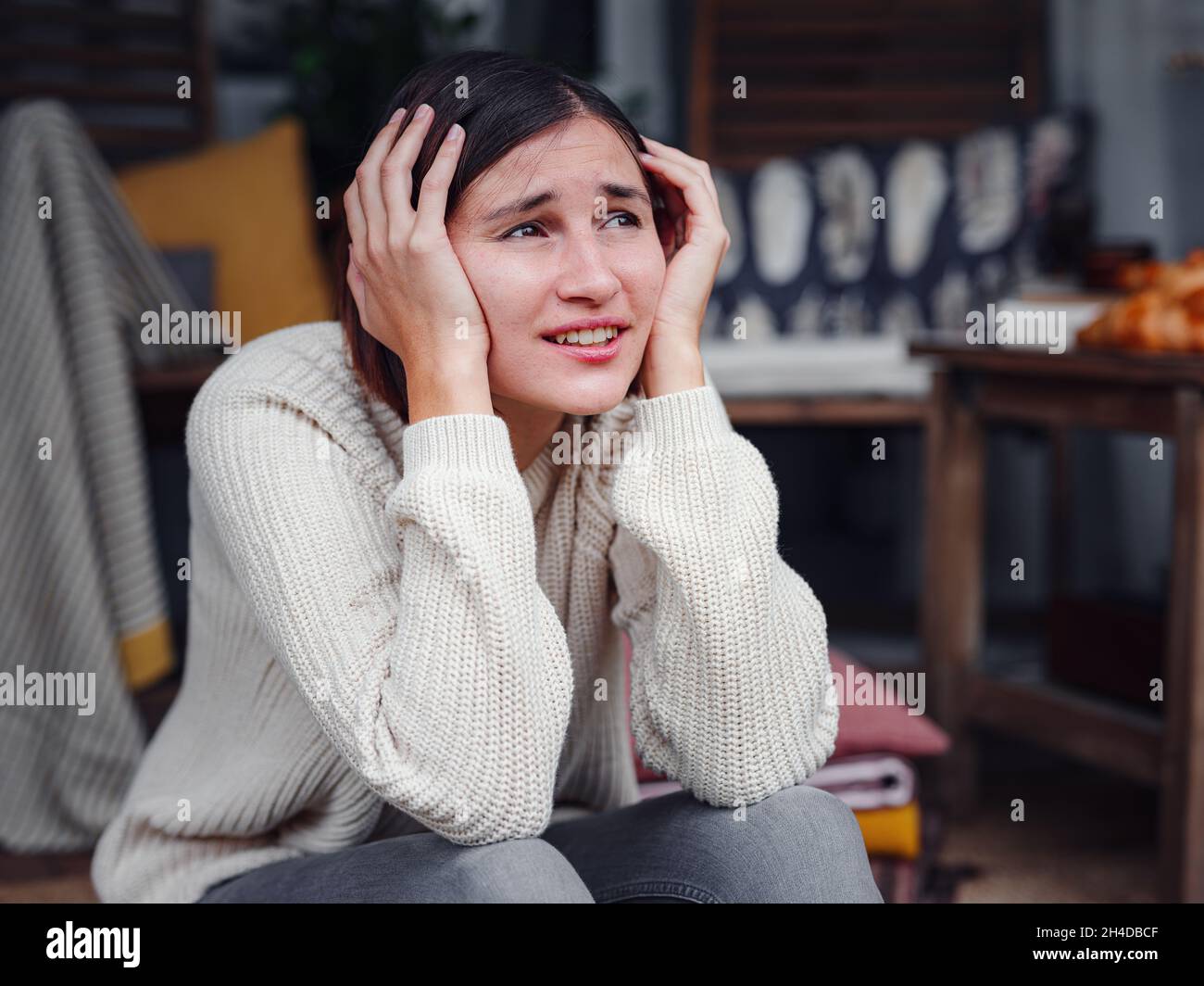 Young depressed asian woman sitting on porch of backyard. She feeling ...