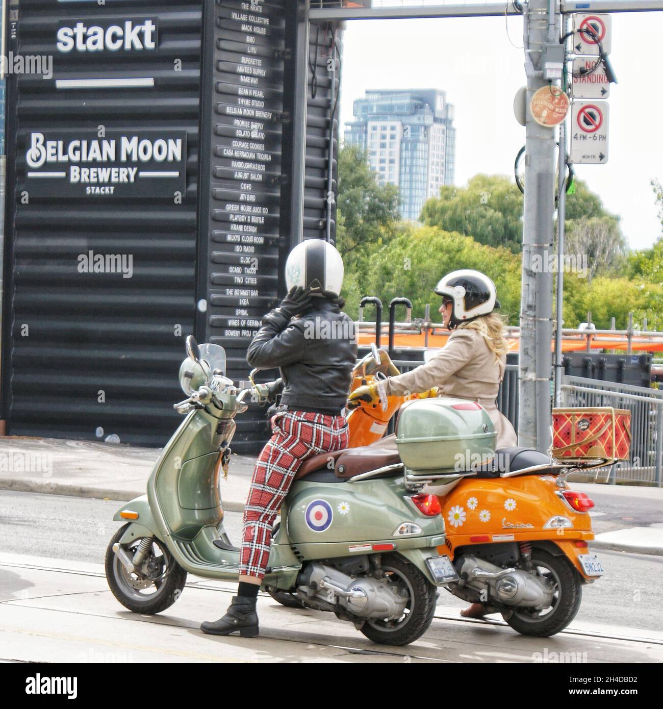 Two ladies on scooters hi-res stock photography and images - Alamy