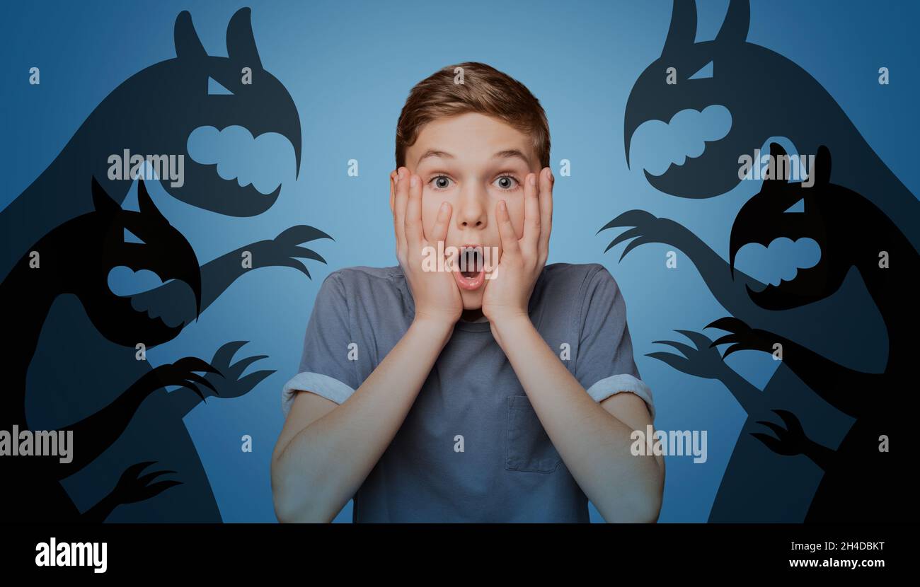 Scared little boy opening mouth and touching his face, afraid of ...