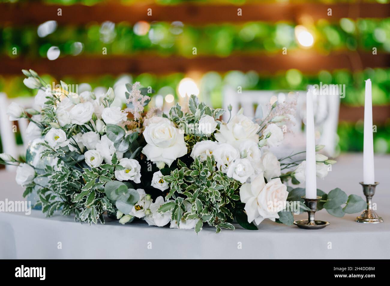 The banquet table is decorated with candles and flower arrangements ...