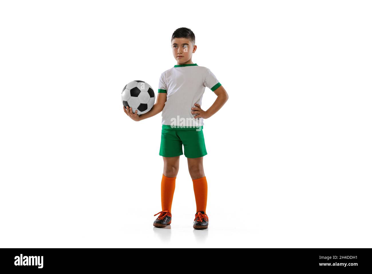 Full-length portrait of boy, child, football player in uniform posing ...