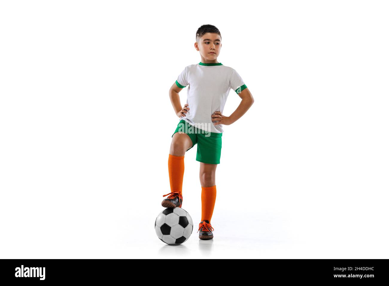 Full-length portrait of boy, child, football player in uniform posing ...