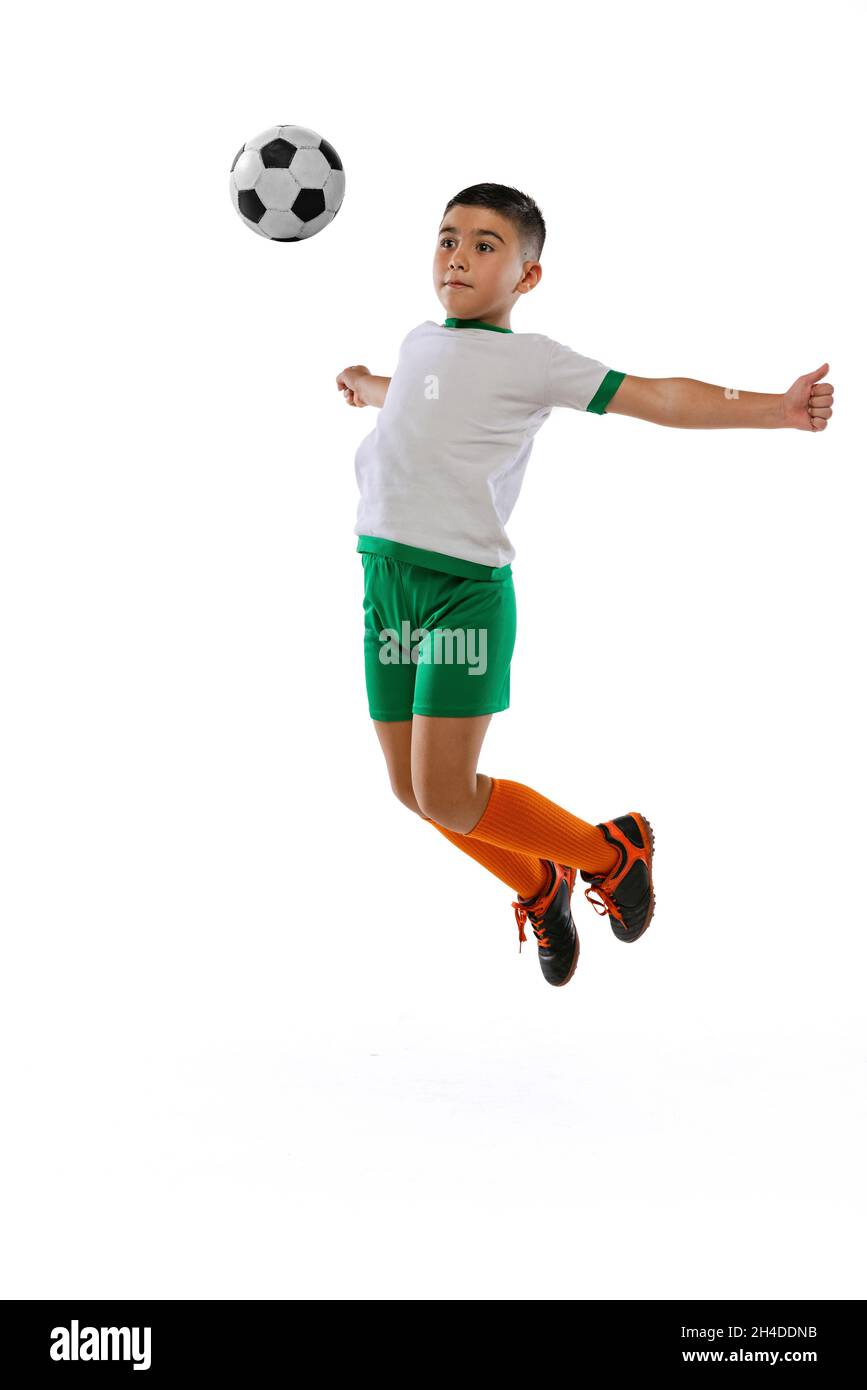 Full-length portrait of boy, child, football player in uniform training ...