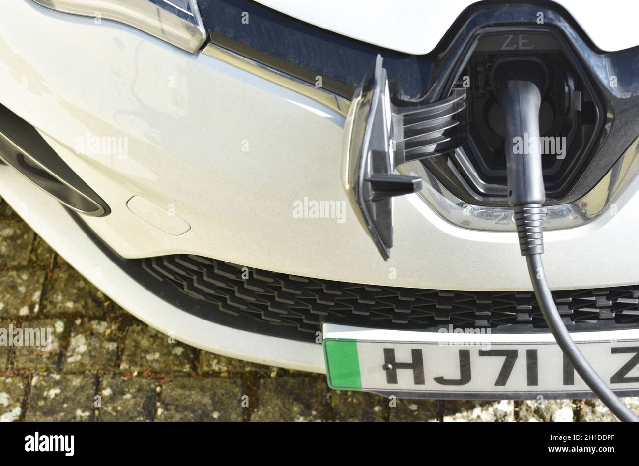A close up of the front of an electric vehicle or EV charging in a ...