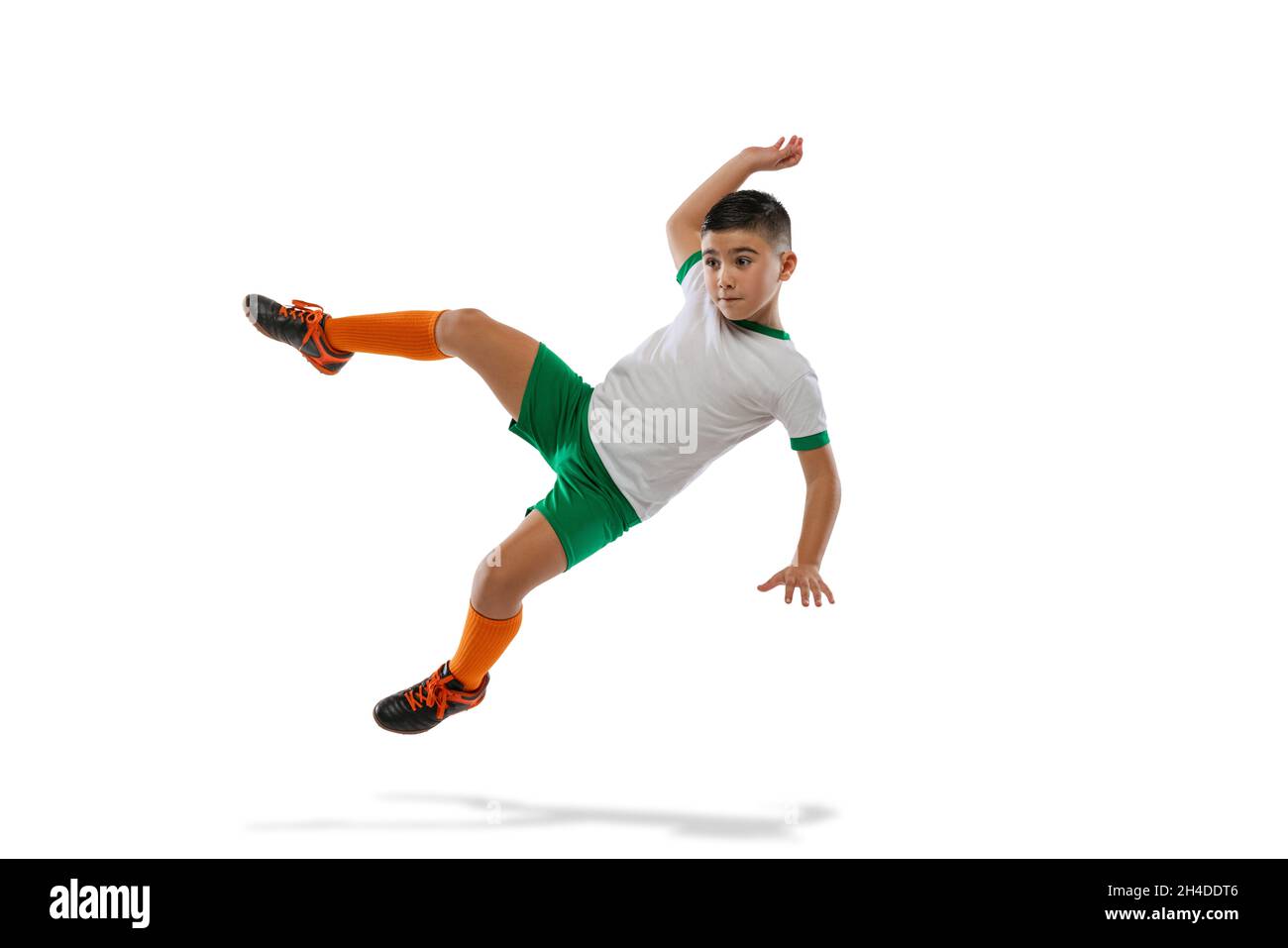 Full-length portrait of boy, child, football player in uniform training ...