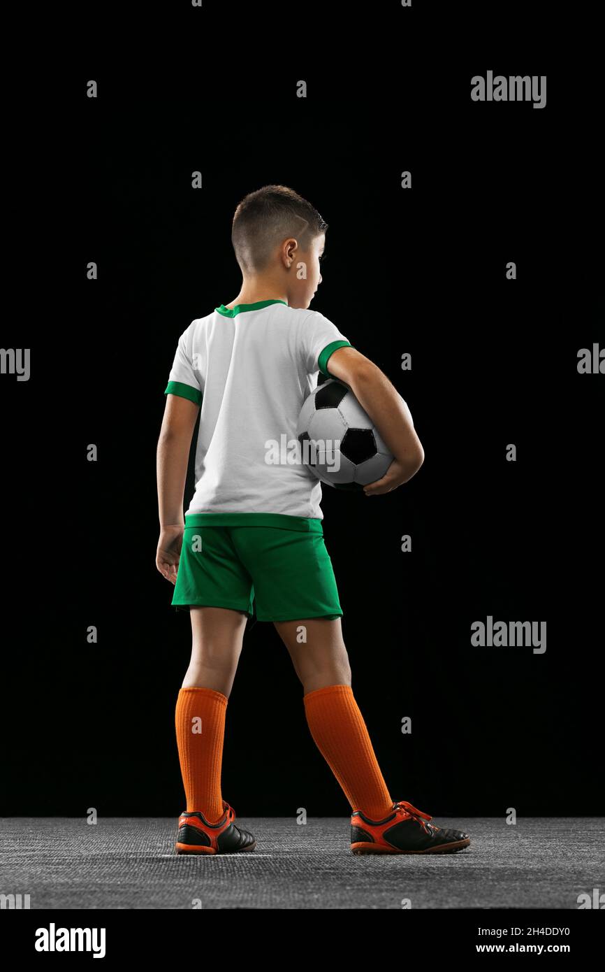 Full-length portrait of boy, child, football player in uniform posing ...