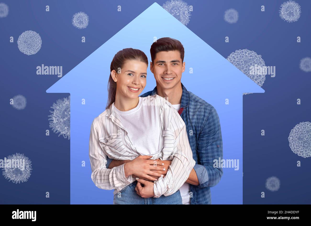 Beautiful young couple standing inside house shape frame and hugging ...