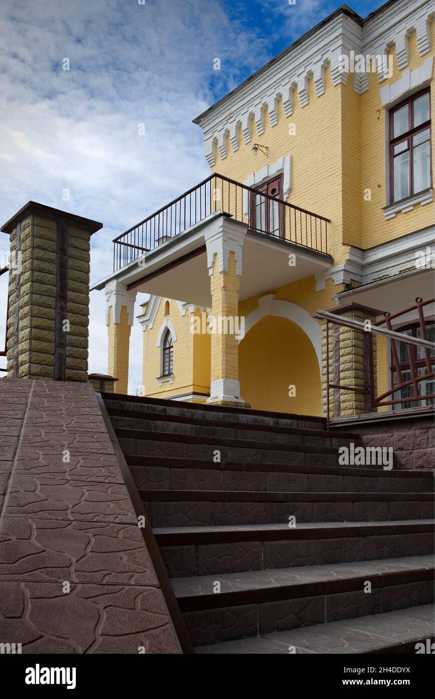 Old yellow manor with stairs Stock Photo - Alamy