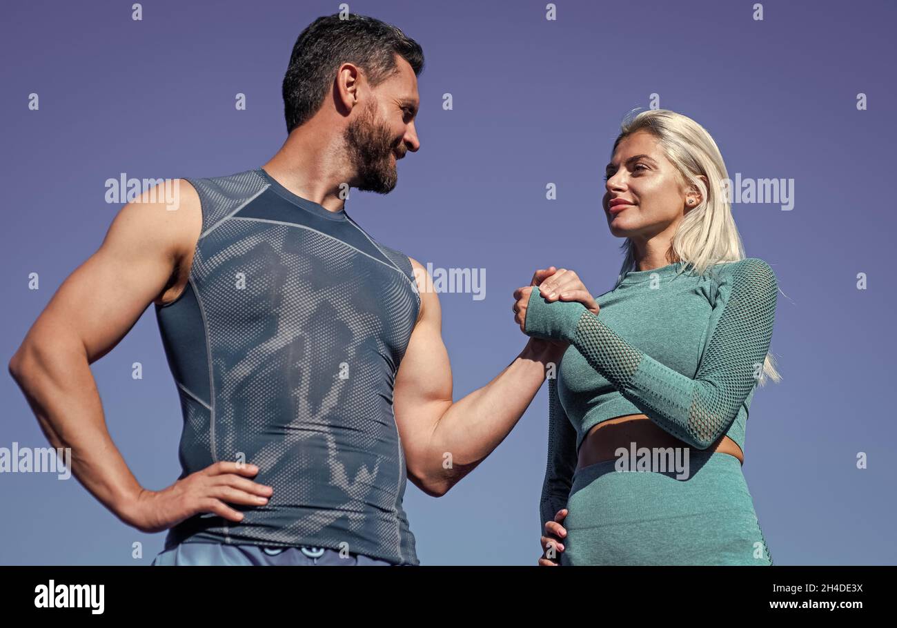 athletic couple arm wrestling in fitness wear outdoor, team Stock Photo ...