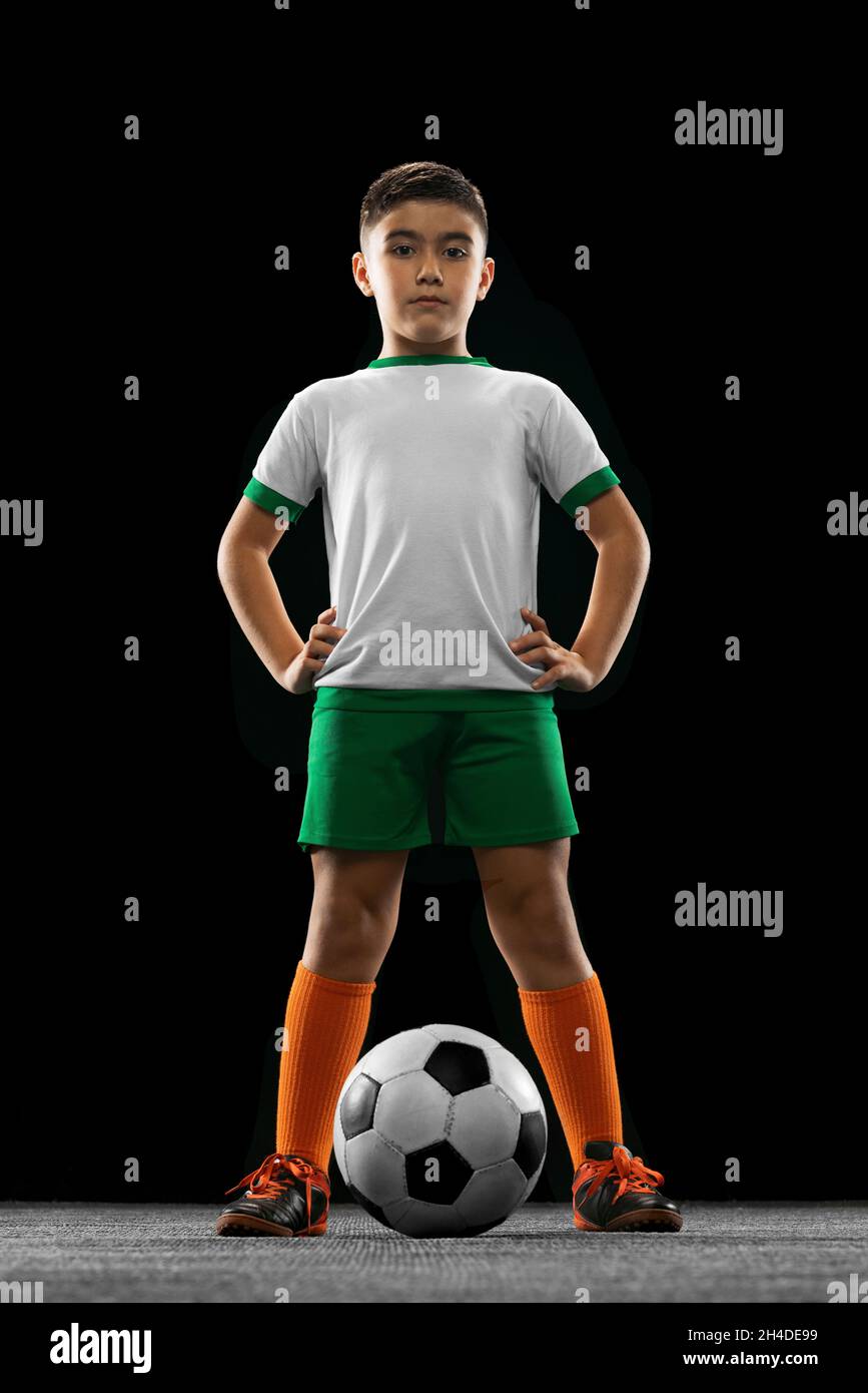 Full-length portrait of boy, child, football player in uniform posing ...