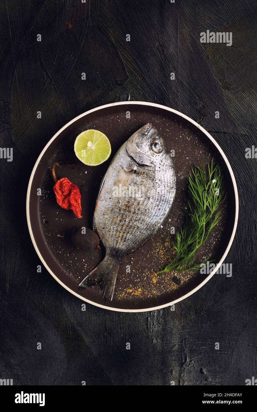 Medium sized fish with a little lemon Stock Photo - Alamy
