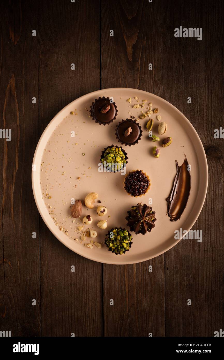 A brown dish that contains the most beautiful and delicious chocolates ...