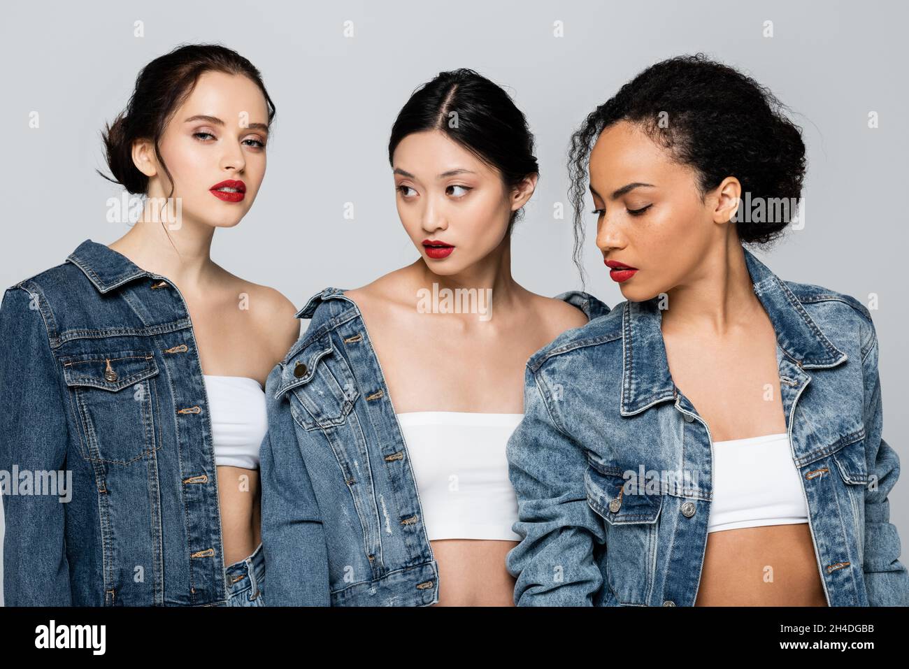 Pretty multicultural women with red lips posing isolated on grey Stock ...
