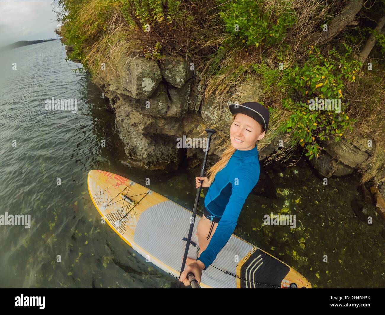 Young Women Having Fun Stand Up Paddling In The Sea Sup Red Hair Girl
