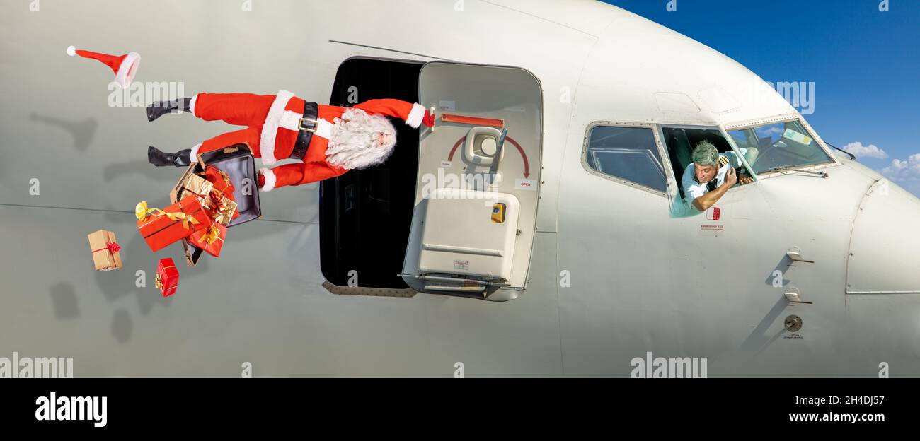 A shocked Santa Claus with gifts in a suitcase holding a handle in the ...