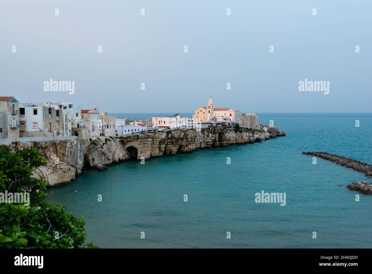 Vieste old town skyline on a cliff over the Mediterranean Sea, with ...