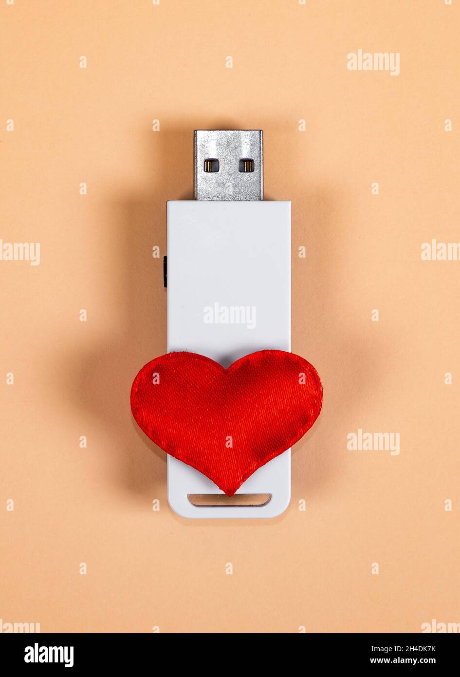 USB Flash Drive with a Heart Shape on the Paper Background closeup ...