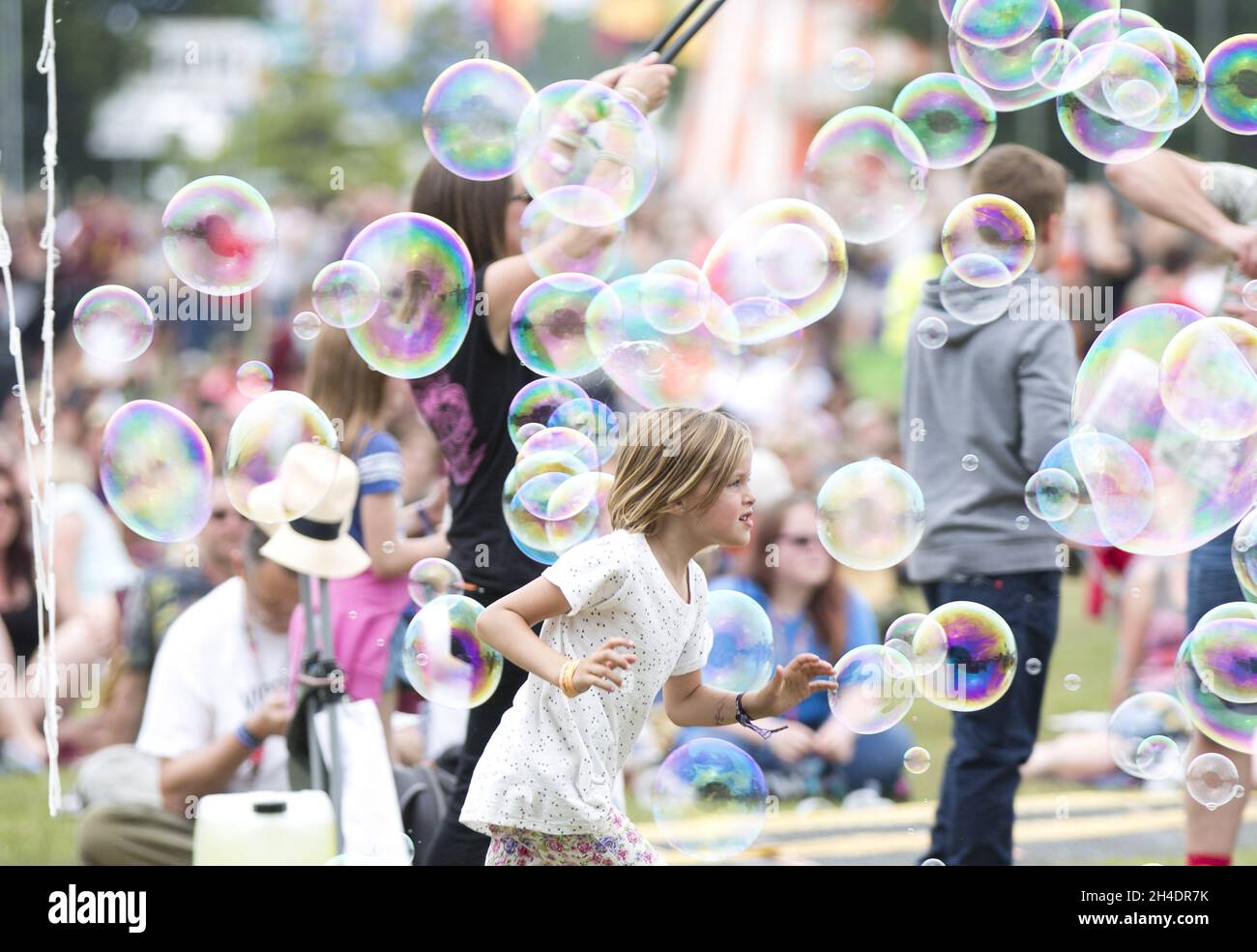 A child run through bubbles at the Isle of Wight Festival, in Seaclose Park, Newport, Isle of ...