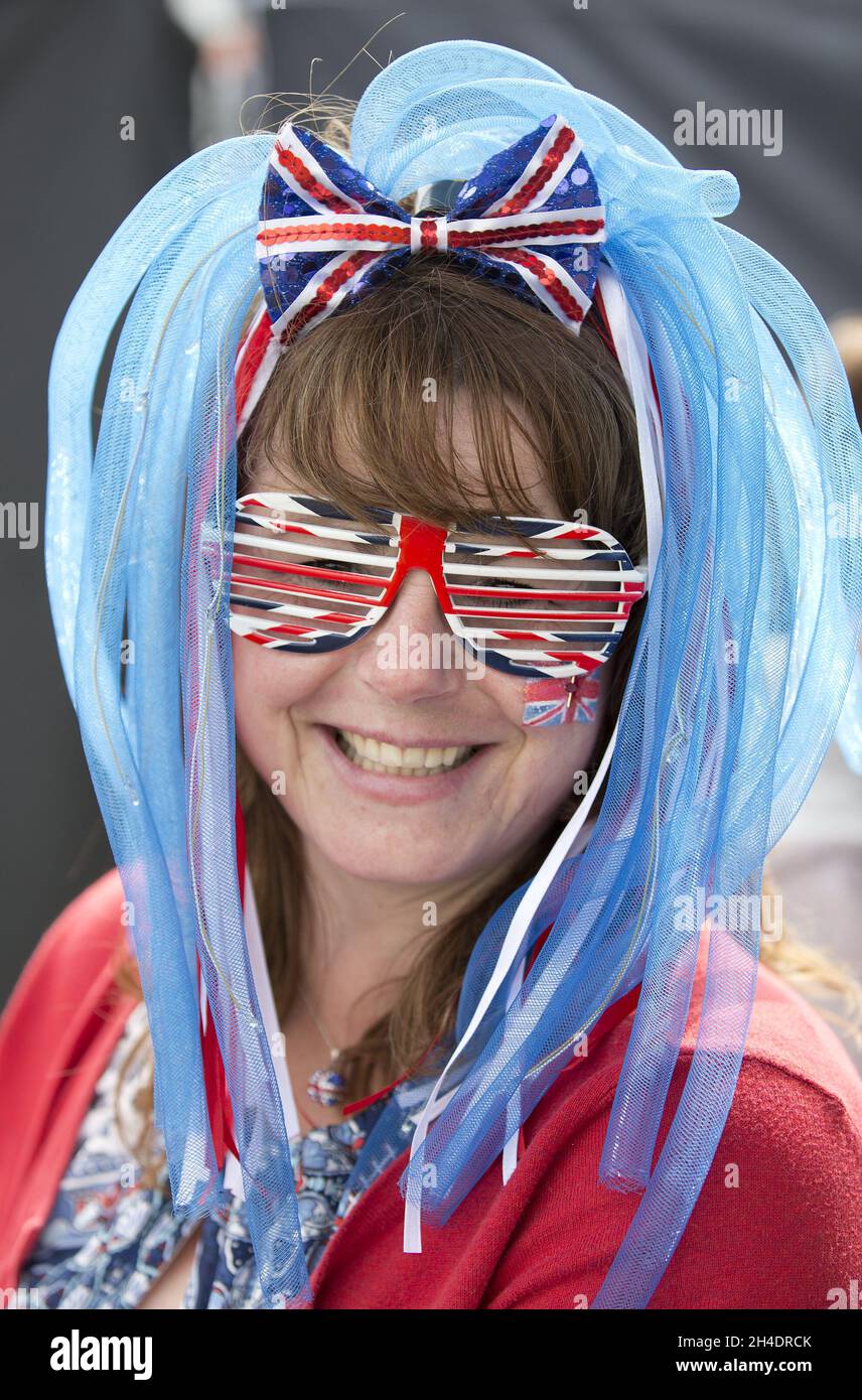 A festival-goer wears Union Jack glasses and wig as she celebrates the ...
