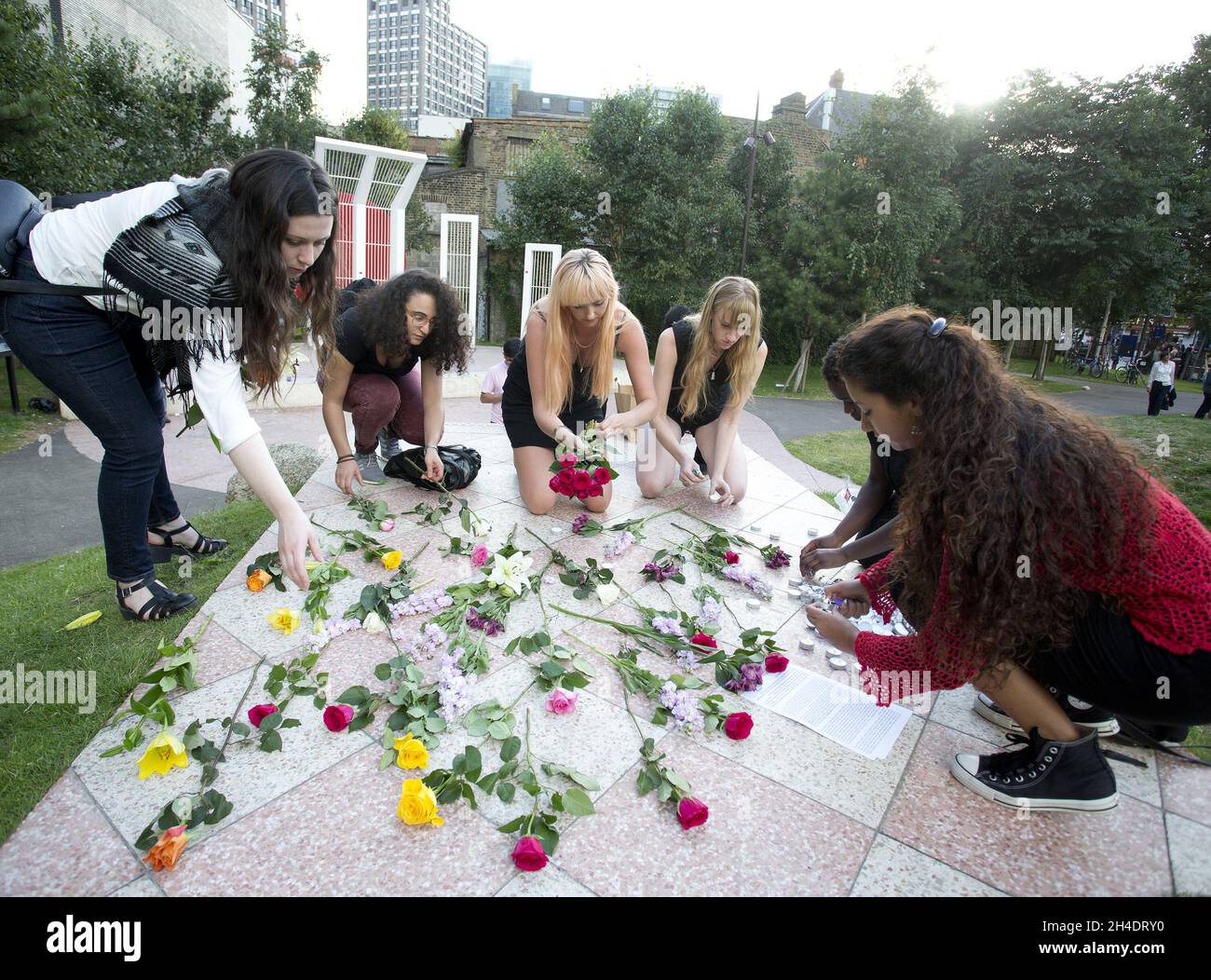 Activists from Black Lives Matter movement place flowers and candles in ...