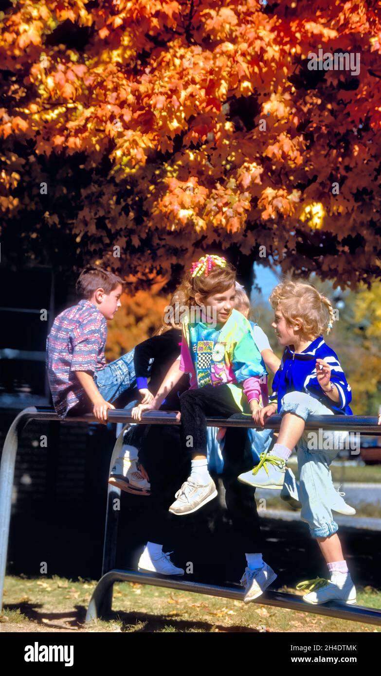 School children play on school playground equipment in the 1980s. Most ...