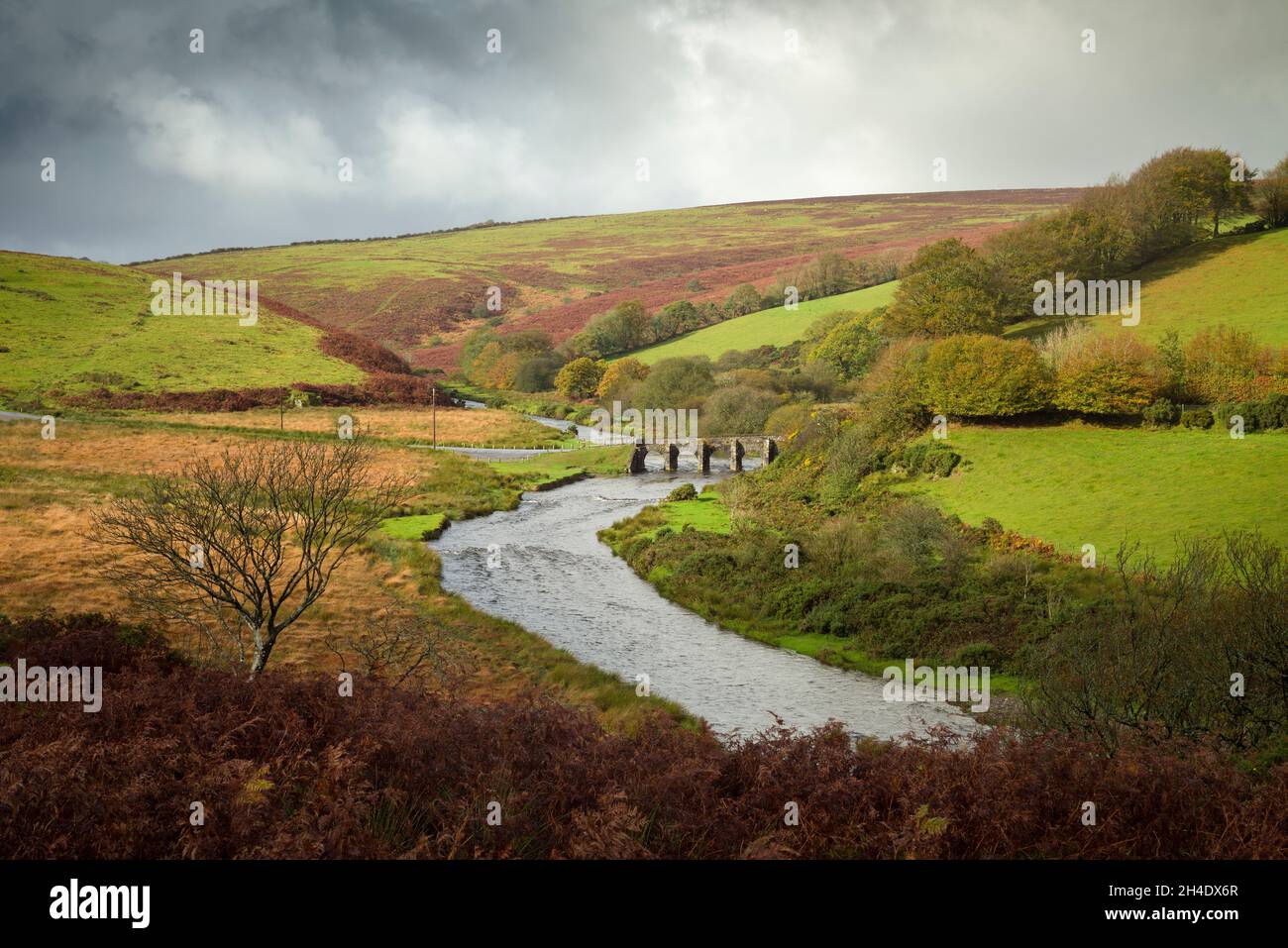 The medieval Landacre Bridge spanning the River Barle in autumn near ...