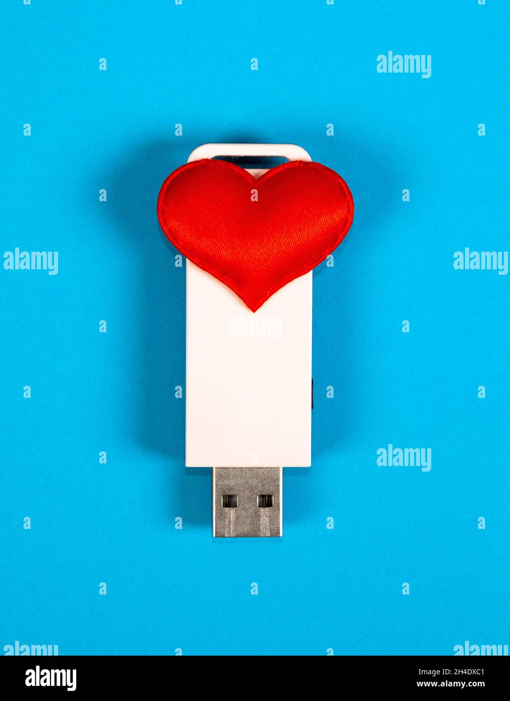USB Flash Drive with a Heart Shape on the Paper Background closeup ...