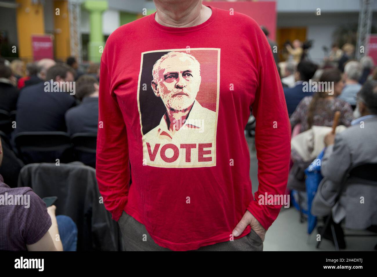 A Labour supporter wears a T-shirt bearing the face of Leader of the ...