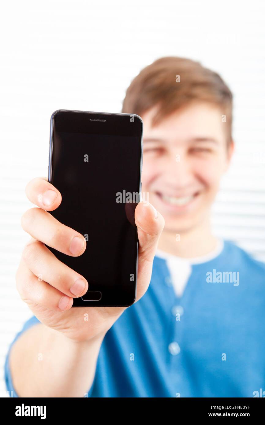 Happy Young Man show a Screen of the Mobile Phone Stock Photo - Alamy