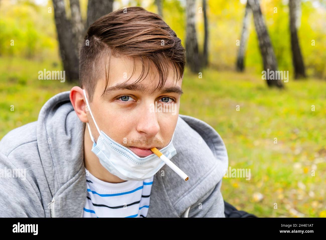 Guy smoking cigarette in forest hi-res stock photography and images - Alamy