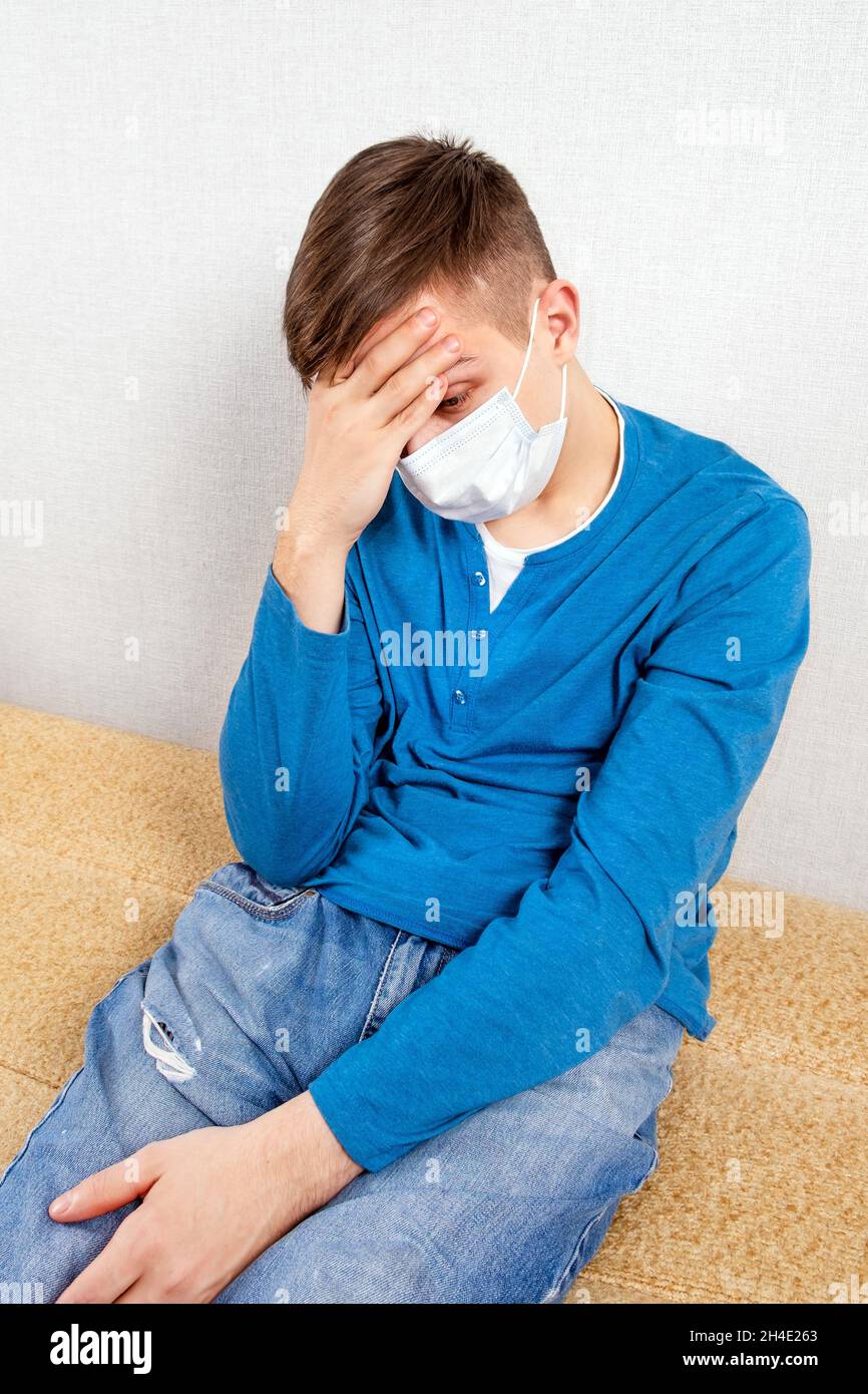 Sad and Sick Young Man in a Flu Mask by the Wall in the Room Stock ...