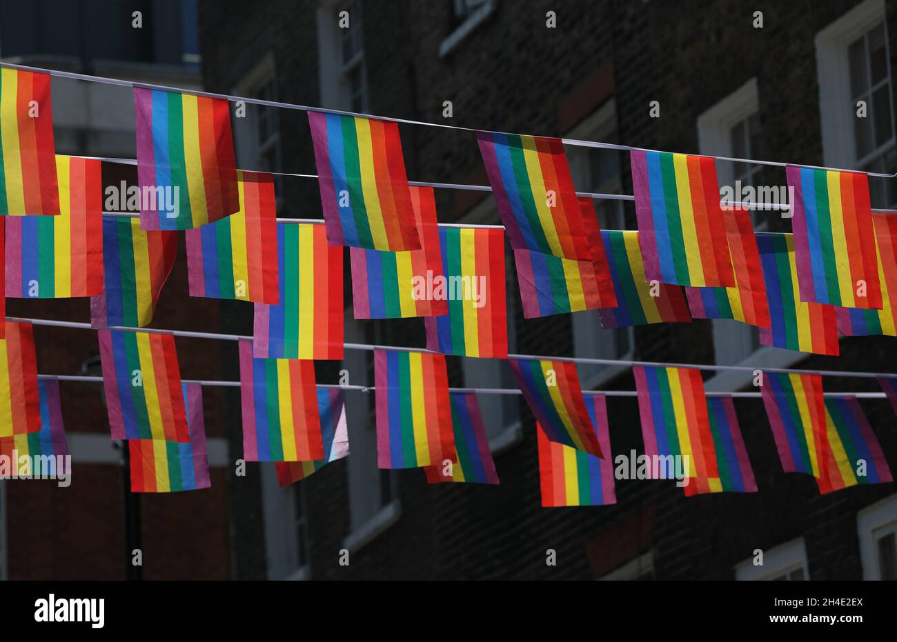 Pride rainbow flags fly on the streets in Soho, London. Picture dated ...