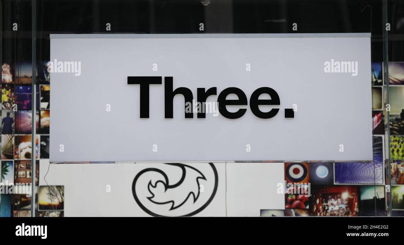 A logo for mobile network Three on a branch at Oxford Street, London ...