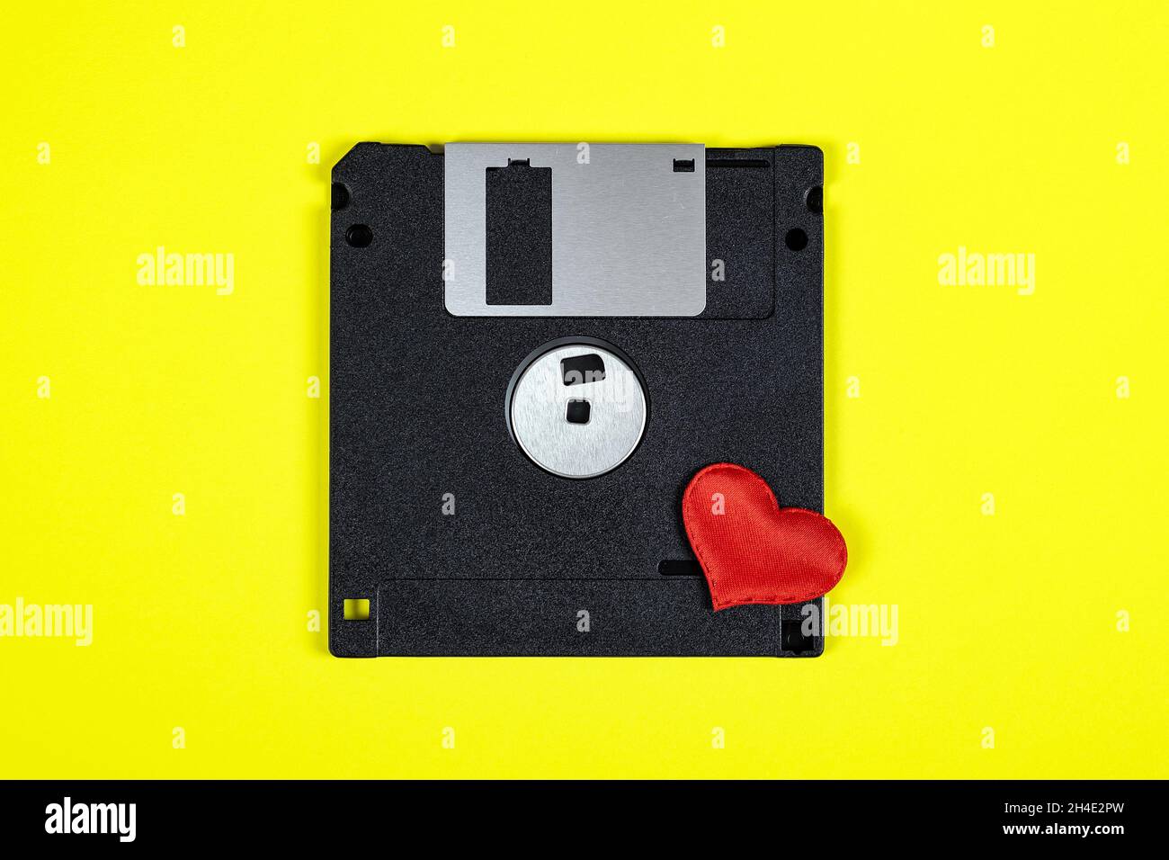 Floppy Disk Drive with a Red Heart on the Yellow Paper Background ...