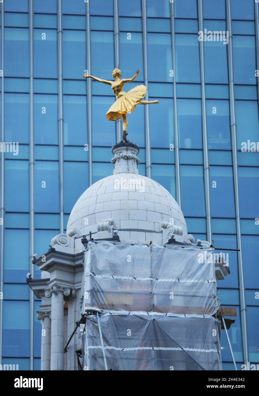 A gilded statue of ballerina Anna Pavlova installed on the Victoria Palace Theatre in London ...