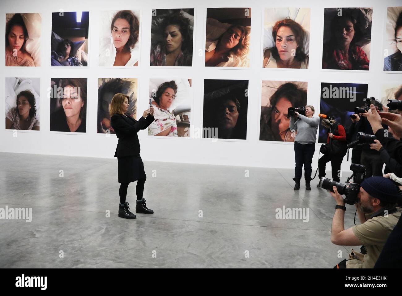 Tracey Emin takes a picture of photographers at the launch of her 'A ...