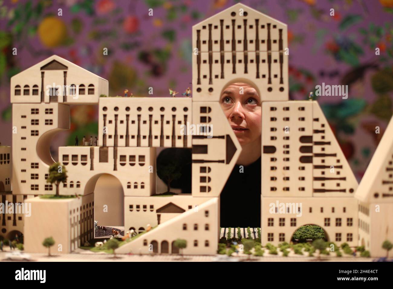 A museum assistant looks at one of the items displayed during the press ...