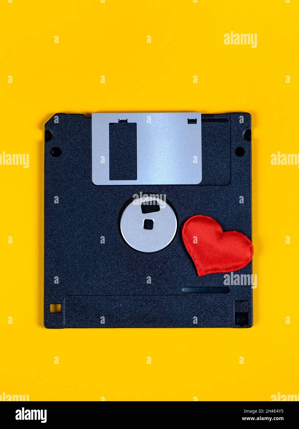 Floppy Disk Drive with a Red Heart on the Yellow Paper Background ...