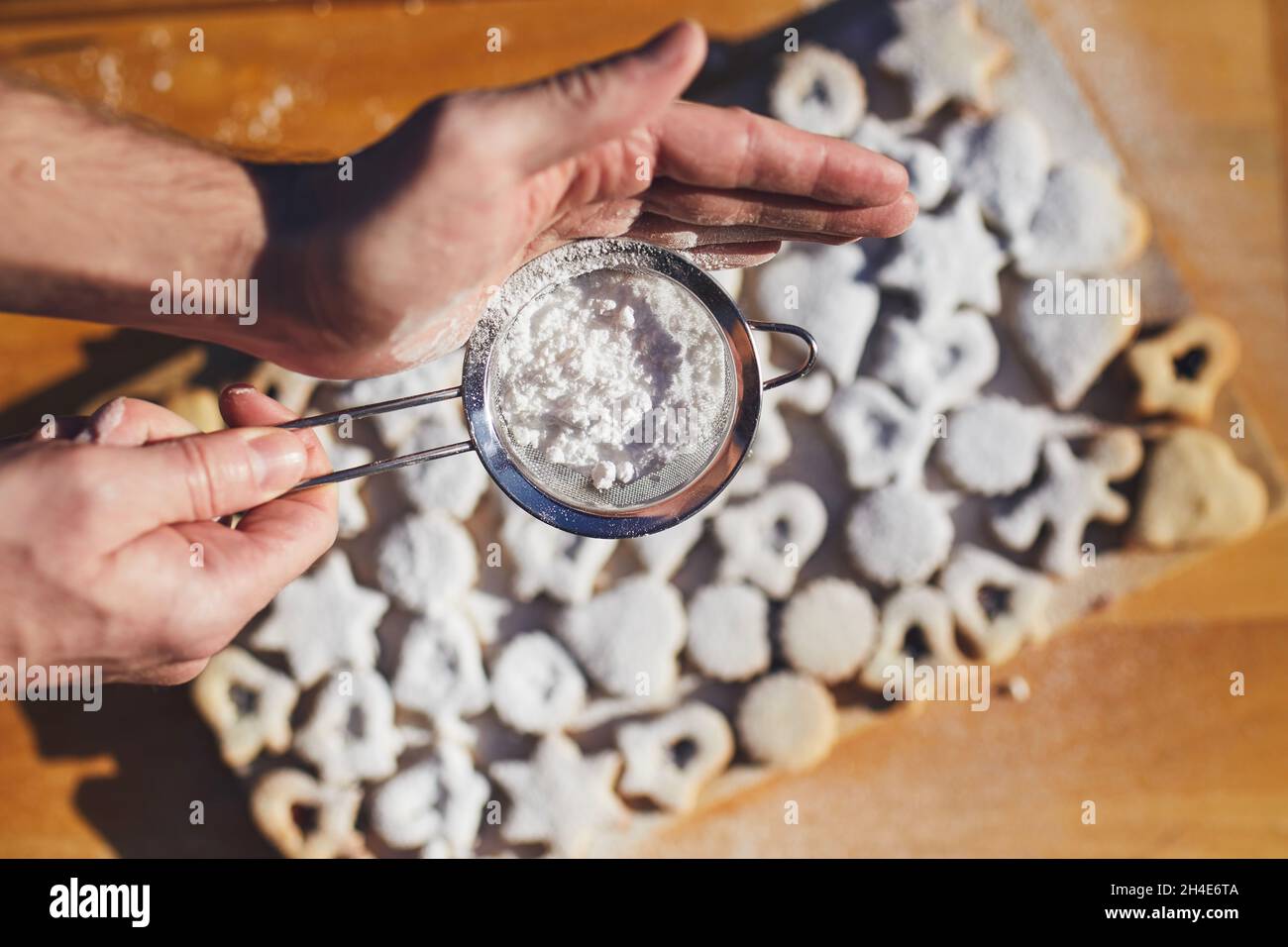 Preparation of Christmas sweets during advent. Powdered sugar falling ...