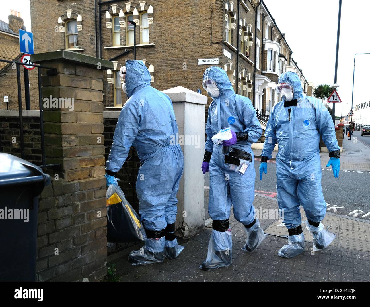 Three police officers wearing Personal Protective Equipment (PPE) as a ...