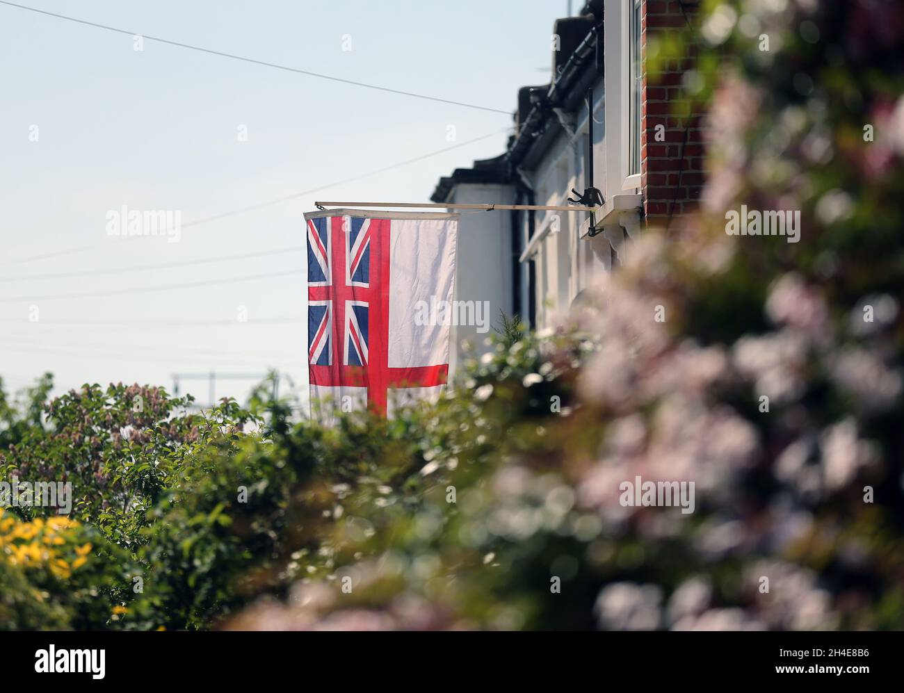 An Union Jack and St George flag is displayed outside a house in ...