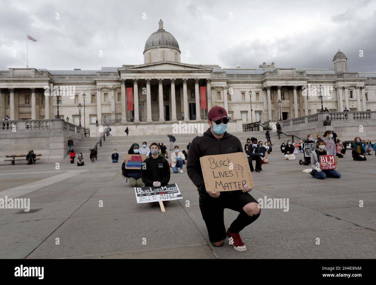 People take part in a kneeling protest for Black Lives Matter in ...