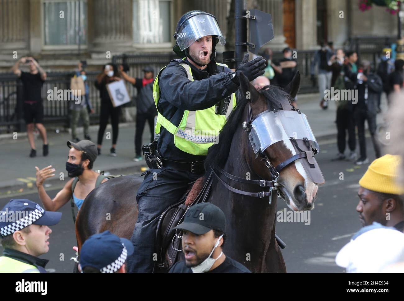 A riot police officer on a horse confronts demonstrators from Black ...